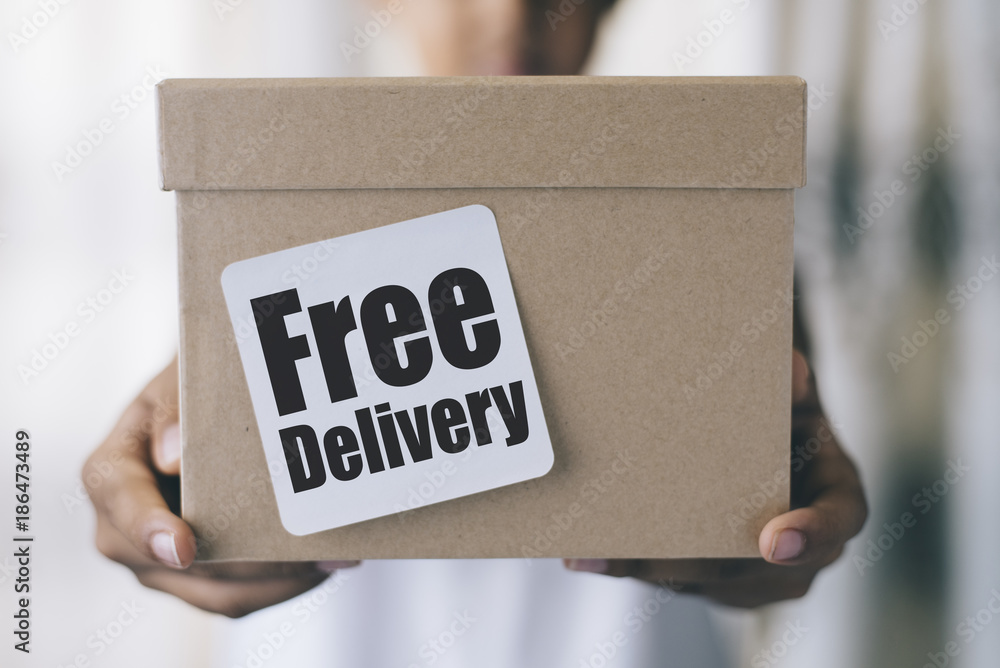 free delivery concept - boy holding brown box with " free delivery ...