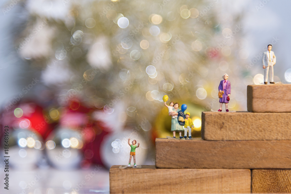 Miniature people with family holding balloon hang out in pine woods ...