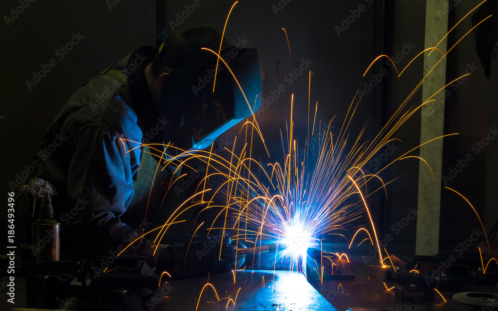 Worker welding construction by MIG welding, Worker welding the steel ...