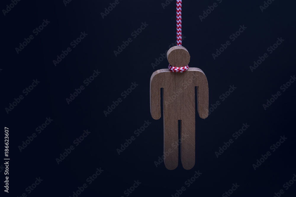Wood figure hanged with a rope Isolated on black background, emotional ...