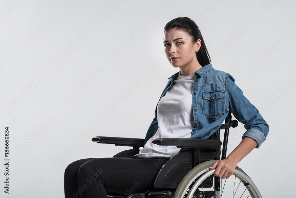 Future ahead. Young budding crippled woman looking at the camera while ...