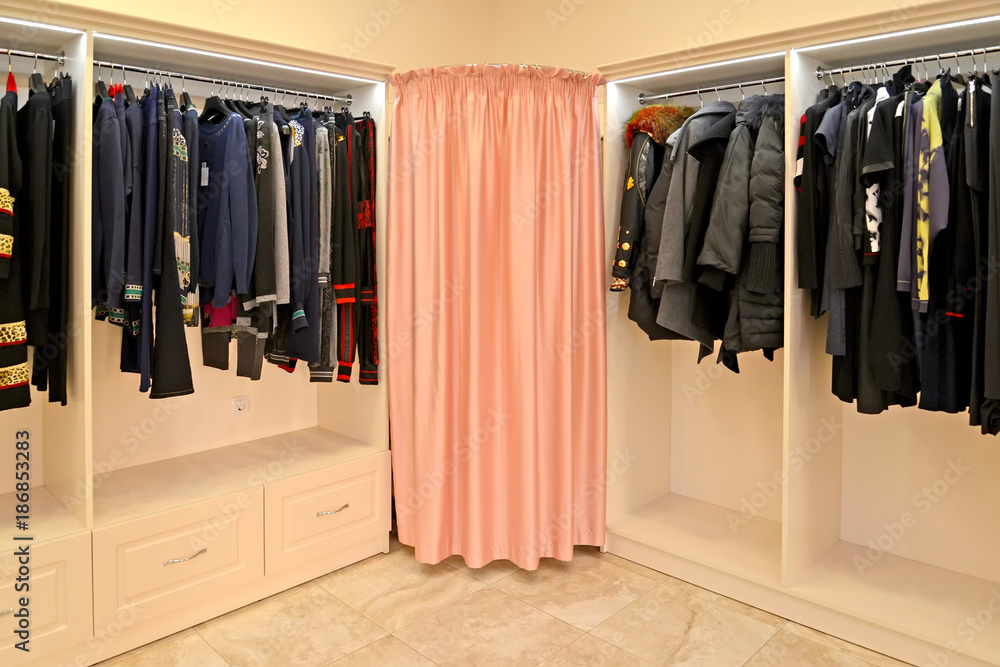 Racks with clothes and an angular fitting room a cabin in shop Stock ...