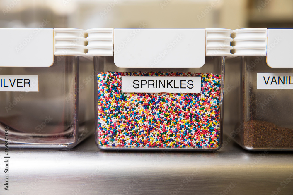 Foto de Sprinkles in labelled container do Stock | Adobe Stock