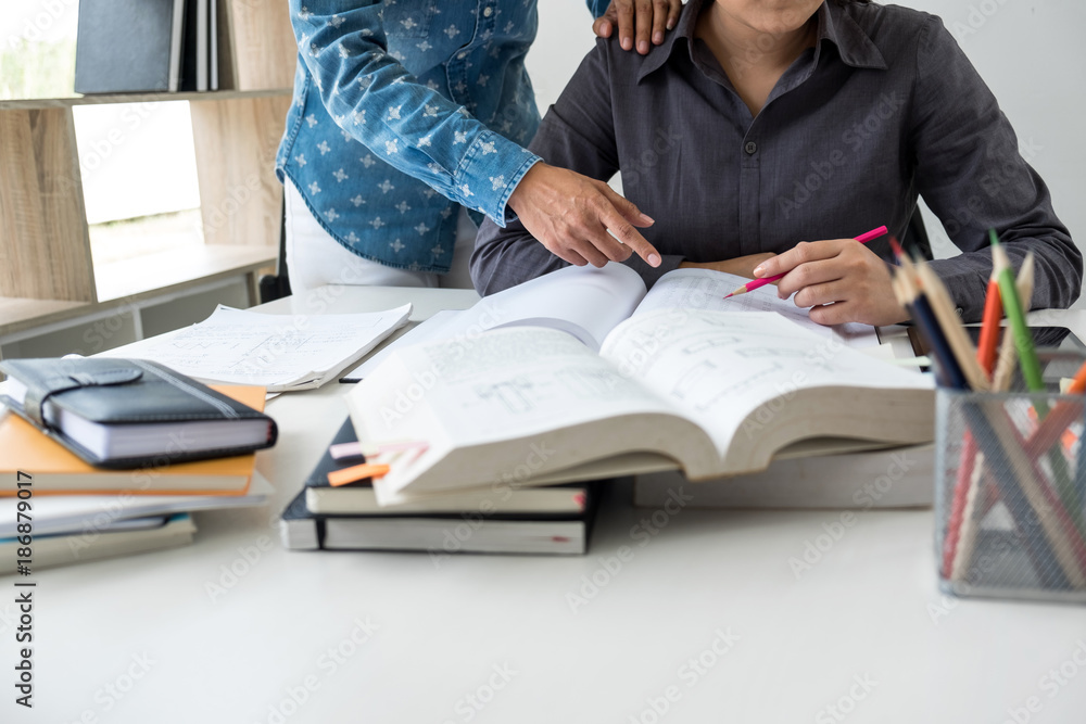 Education, teaching, learning, technology and people concept. Two high ...