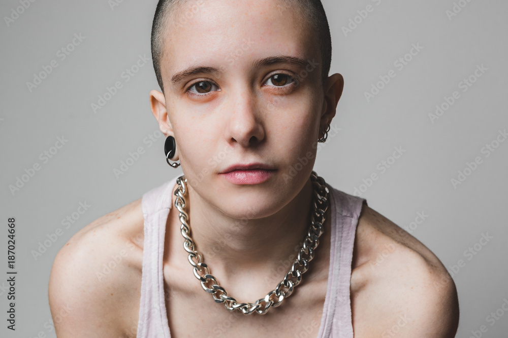 Androgynous Young Woman Posing Tough as a Male Stock Photo | Adobe Stock