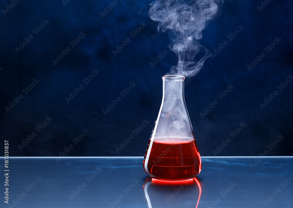 Erlenmeyer flask with red liquid on the tabel. Experiment in the ...