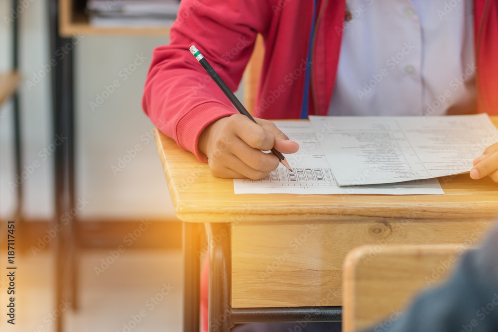 Foto de Asian Students holding pencil in hand doing multiple-choice ...