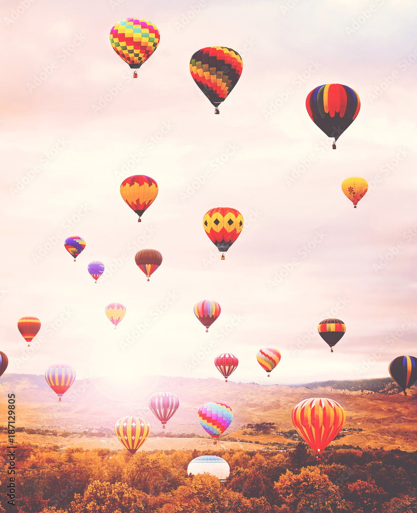 hot air balloons in the sky during sunrise toned with a retro vintage ...