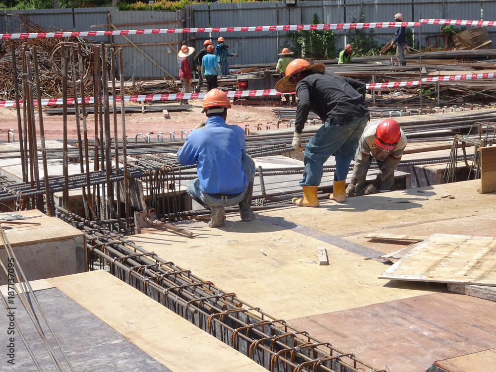 Carpenters fabricate timber and plywood formwork at the construction ...