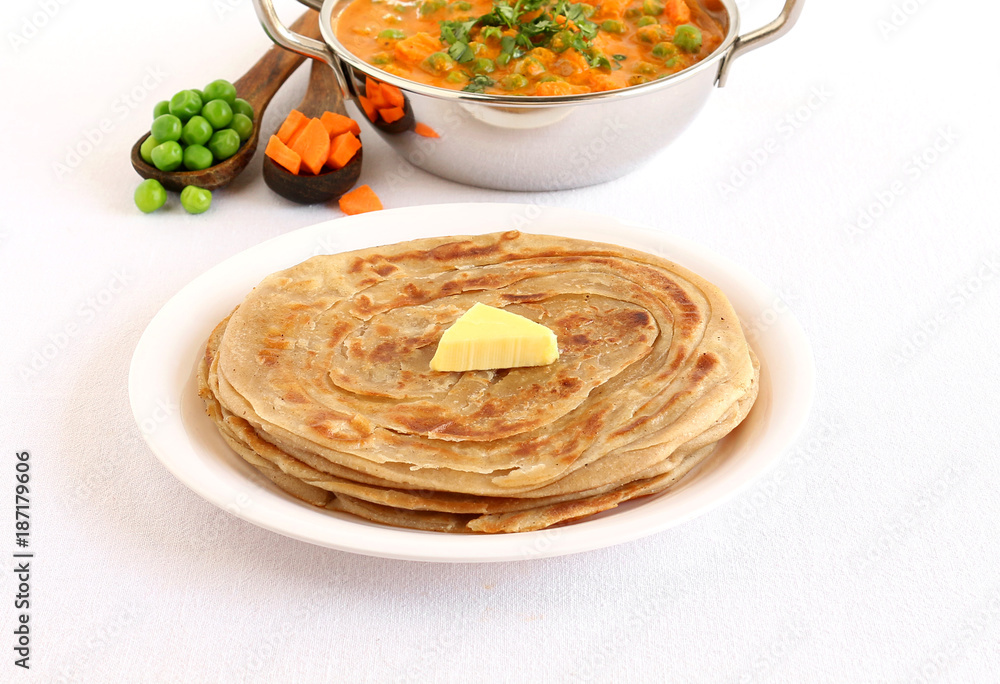 Kerala paratha, a type of Indian bread, with butter topping, and in the ...
