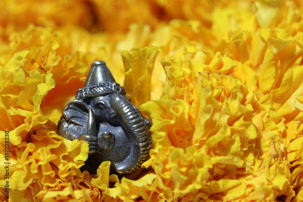 Mini Ganesha made from brass among of yellow marigold flower, the son ...