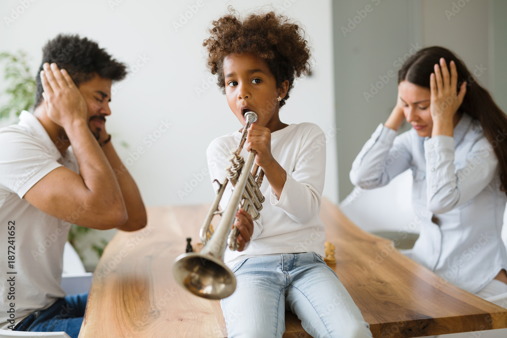 Picture of child making noise by playing trumpet Stock-Foto | Adobe Stock