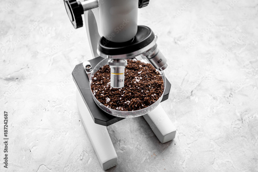 Analysis process. Soil under microscope on grey background Stock Photo ...