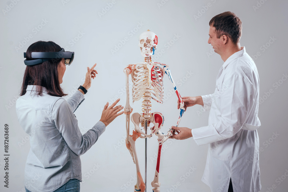 Doctor uses augmented reality goggles and human skeleton for teaching ...