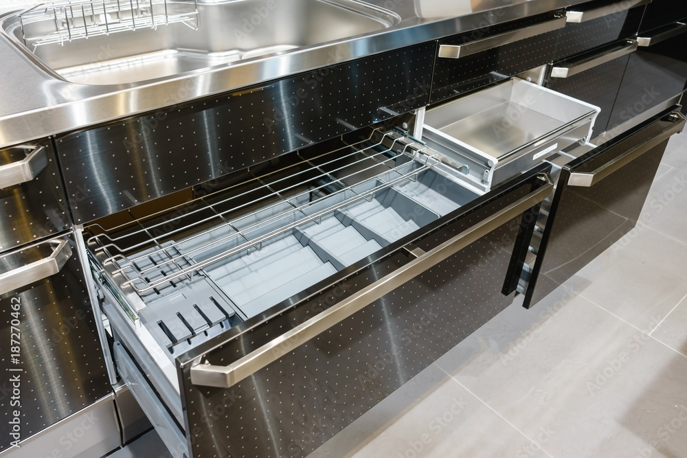 Opened kitchen drawer with plates inside, a smart solution for kitchen ...