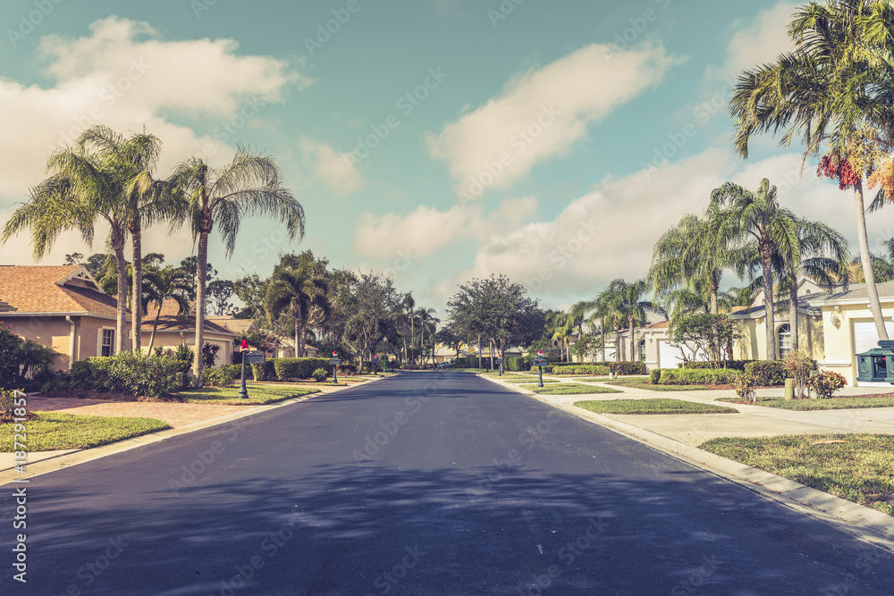 Asphalt road through gated community subdivision, South Florida ...