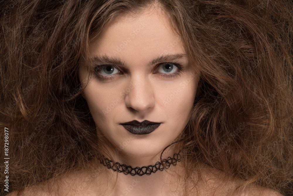 Beautiful girl witch with curly hair on black background for holiday ...