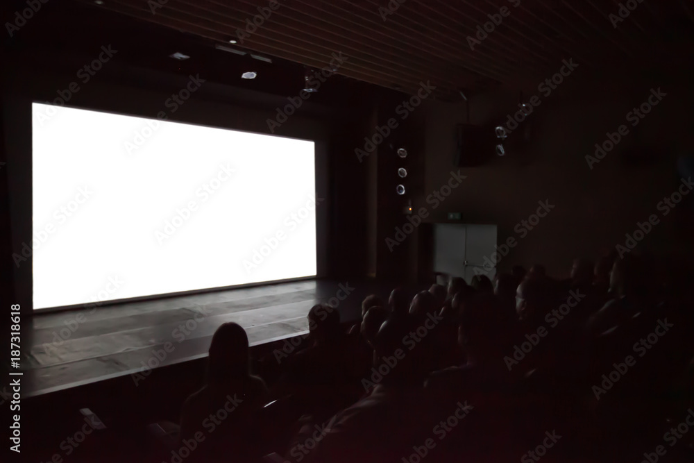 Blurry background of people watching movie in the movie theater with ...