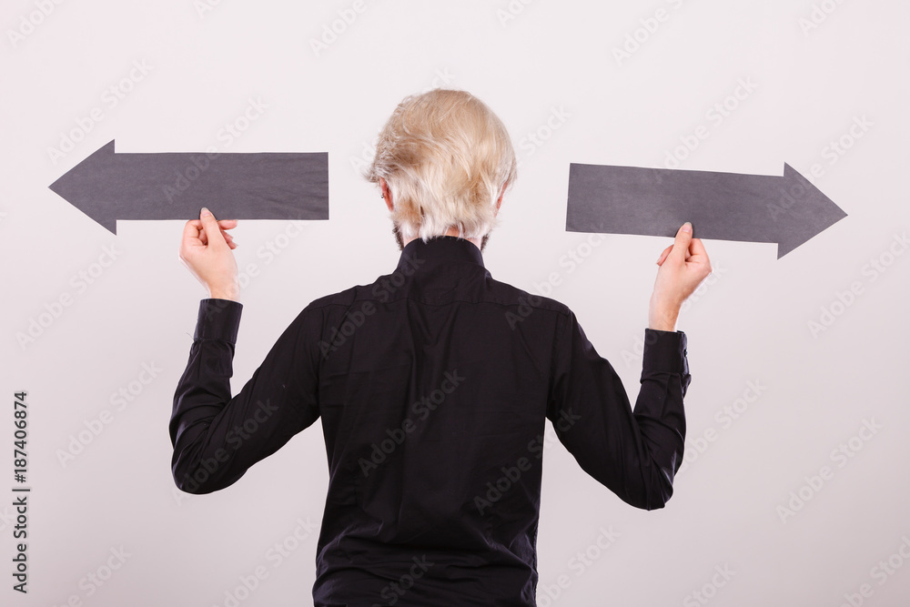 Man holding black arrows pointing left and right Stock Photo | Adobe Stock