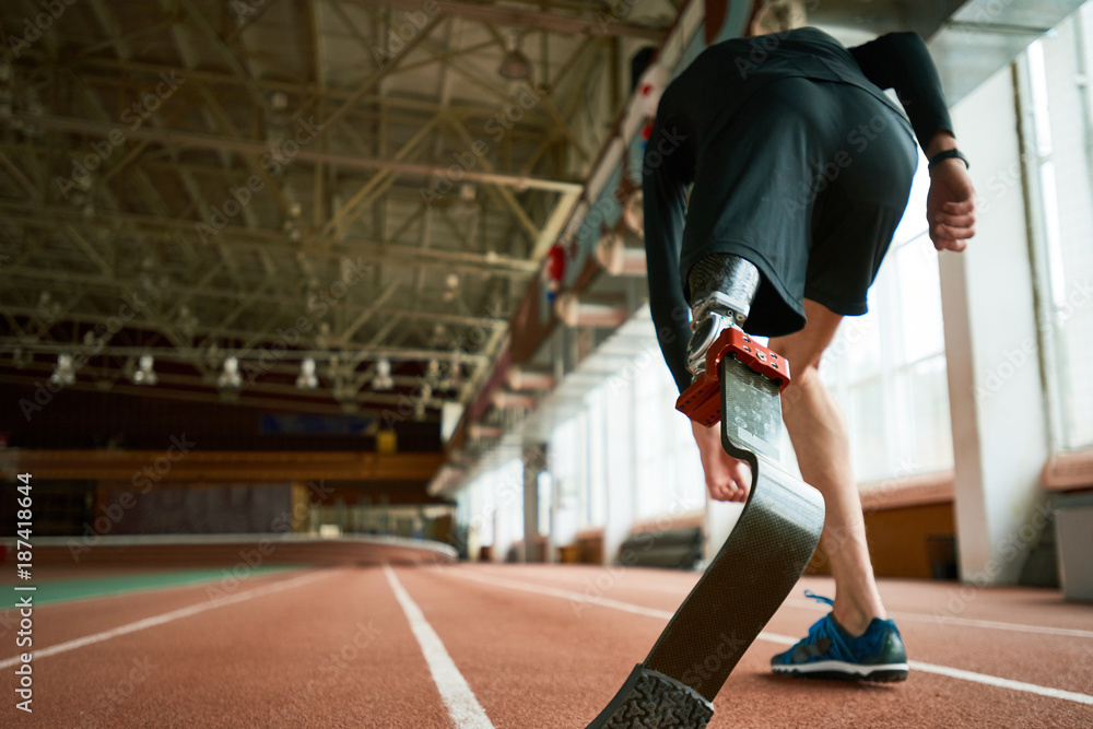 Motivational image of young amputee athlete on start position on ...