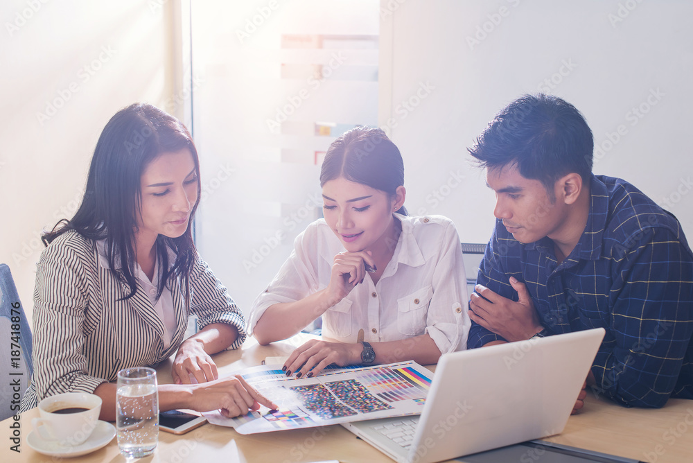 group of designer working graphic on computer with color chart and ...