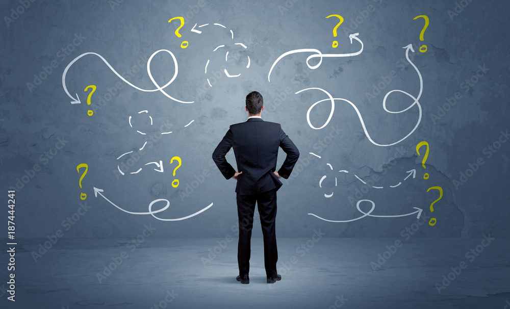 Unsure businessman with question marks Stock Photo | Adobe Stock