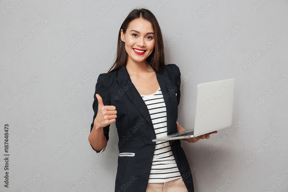 Holding business woman holding laptop computer and showing thumb up ...