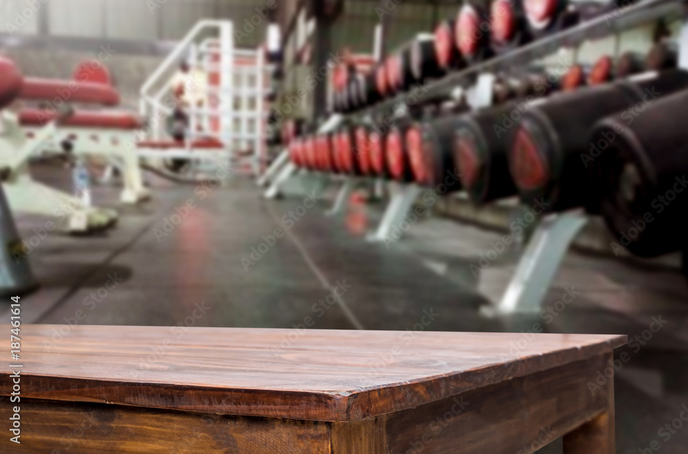 Wooden table on blurred background of fitness gym interior of modern ...