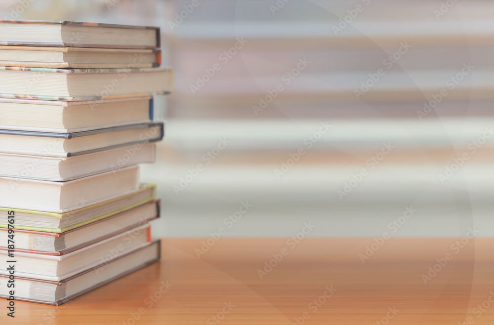 Book stack in the library room and blurred bookshelf for business and ...