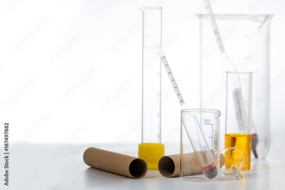 Glass thermometer and a hydrometer along with a laboratory glass on a ...