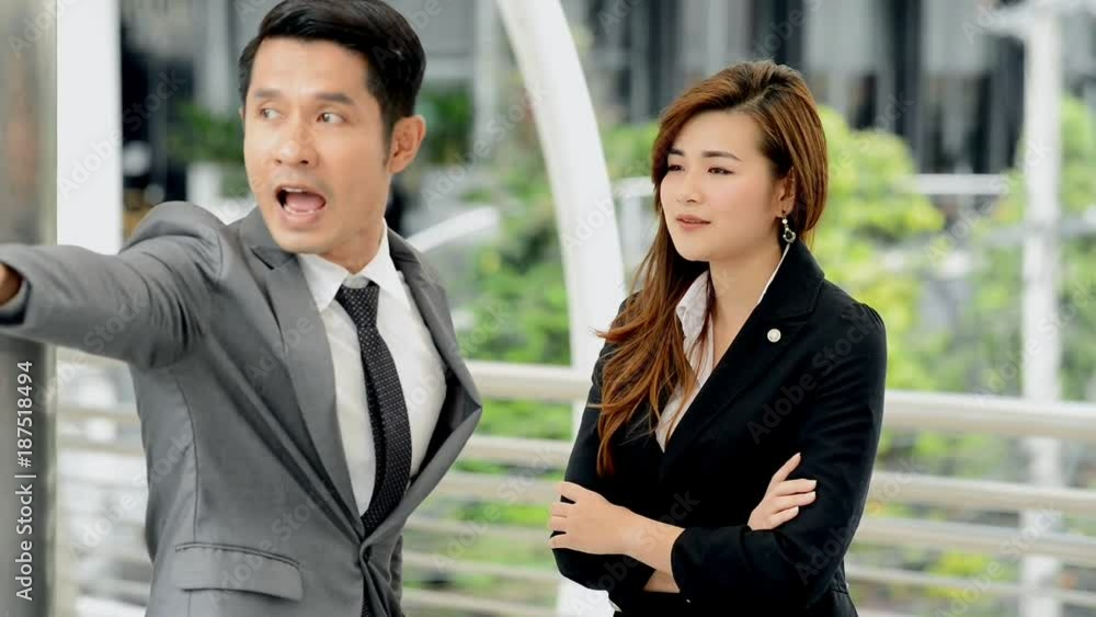 Angry business man talking violently with woman. Young chinese man and ...