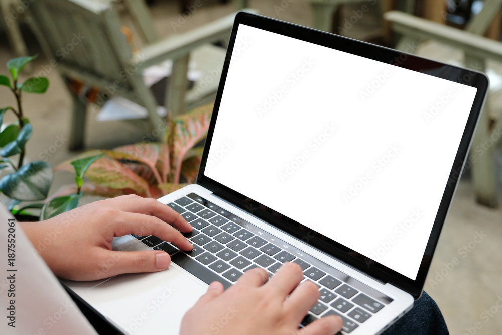 Man hands typing laptop computer with blank screen for mock up template ...