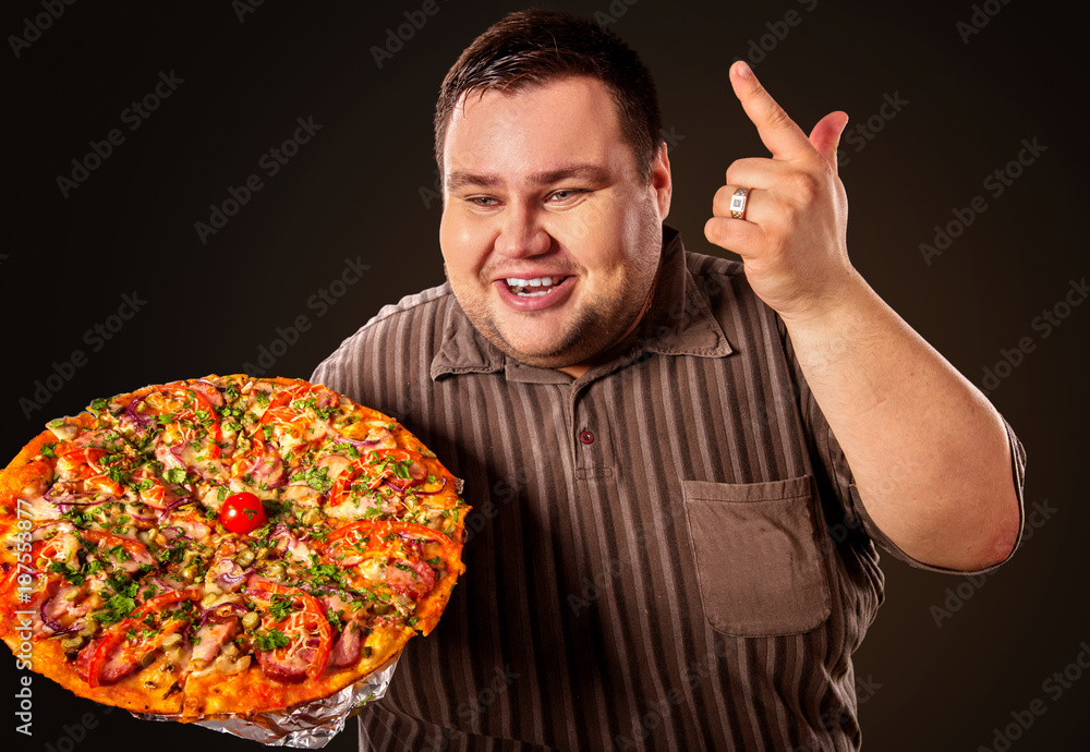 Fat man eating fast food and offers great pizza to customers . Male ...