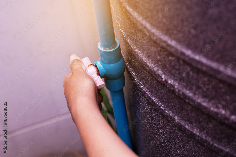 Hand using water pipes and water tank for consume Stock Photo | Adobe Stock