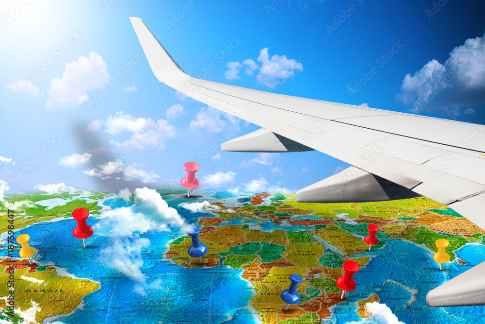 Flying around the world with aircraft wing overshadowing the earth map ...