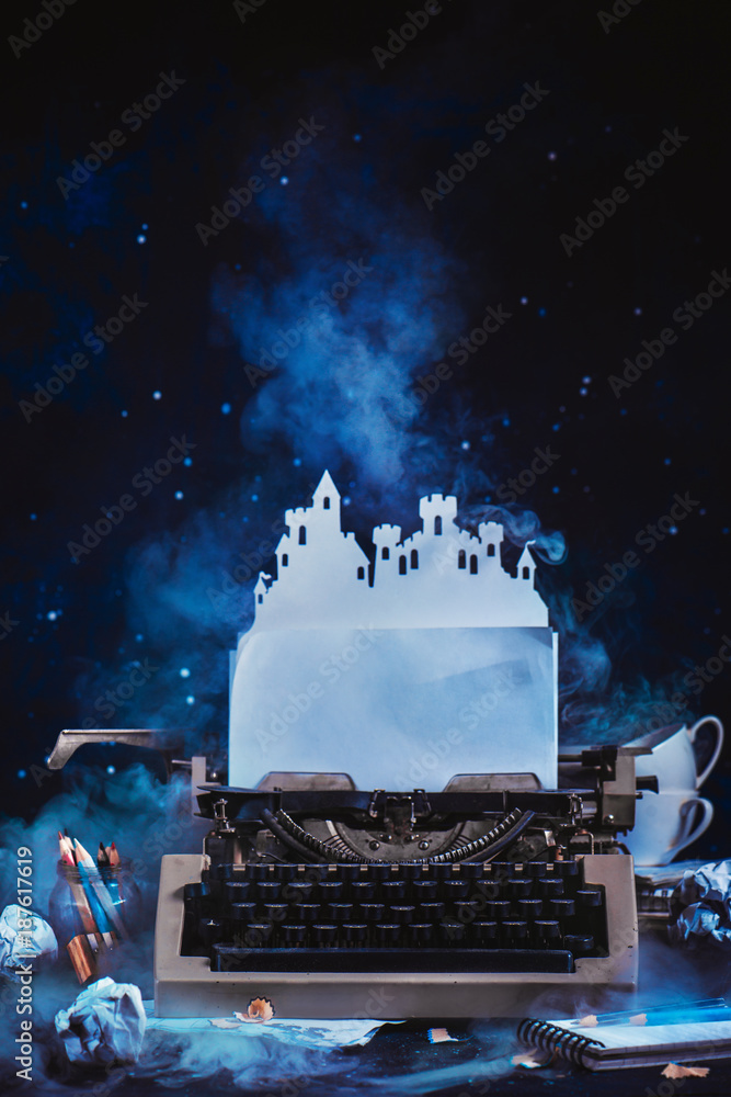 Fantasy writer workplace with a typewriter and paper castle. Fortress ...