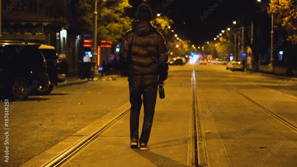 Drunk Man is Walking by the Night Carriageway Street and Drinking Beer ...