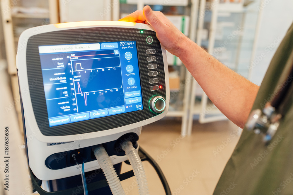 doctor man adjusts medical device with monitor Stock Photo | Adobe Stock
