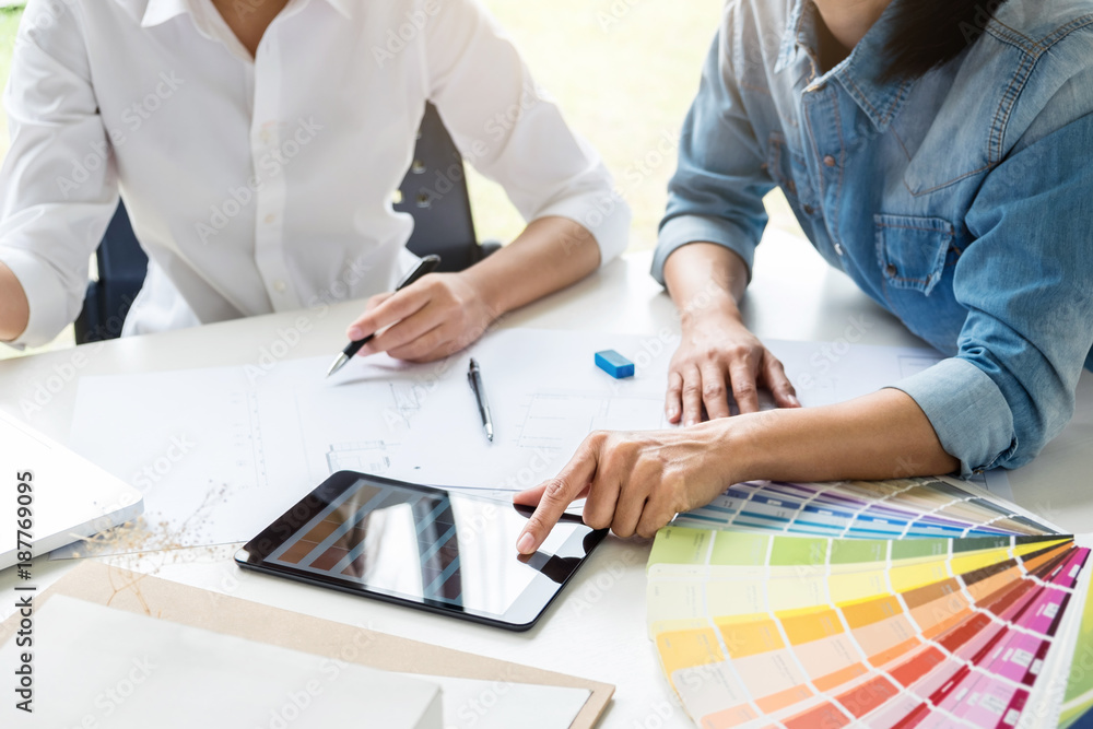 Two interior design or graphic designer at work on project of ...