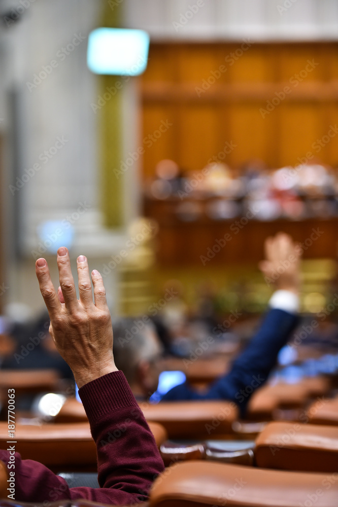 Hand raised in the air during a voting procedure Stock Photo | Adobe Stock