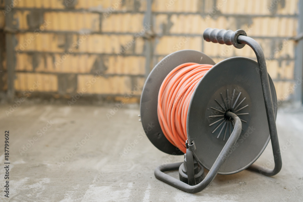 Orange power extension cable reel at the construction site Stock Photo ...