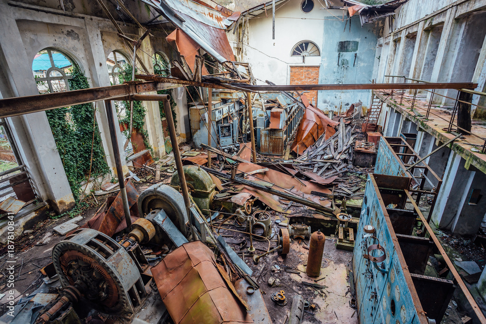 Ruined abandoned electrical substation. Rusty generator at machinery ...