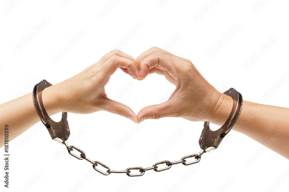 Hands of a couple forming a heart shape with handcuffs / Love and ...