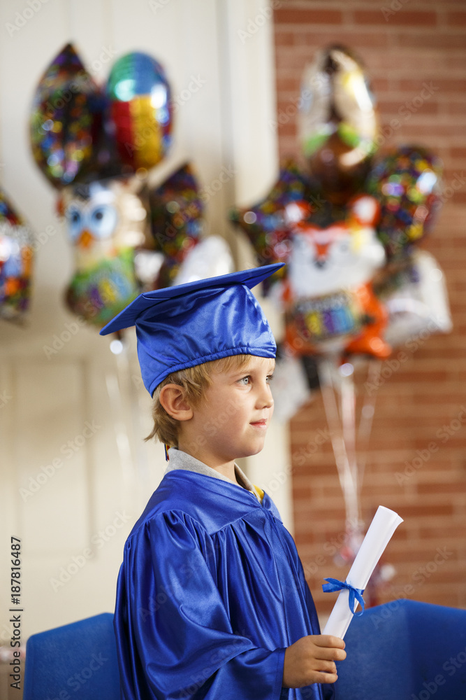 Caucasian boy wearing graduation robe holding diploma Stock Photo ...