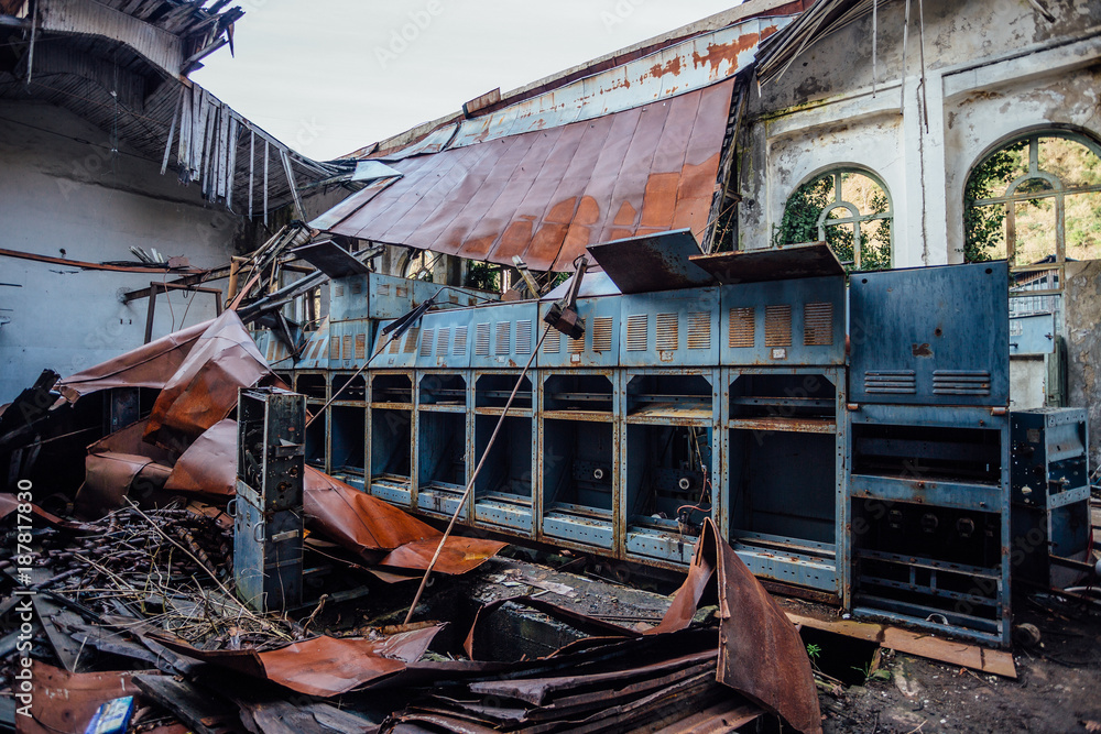 Ruined abandoned electrical substation. Rusty generator at machinery ...