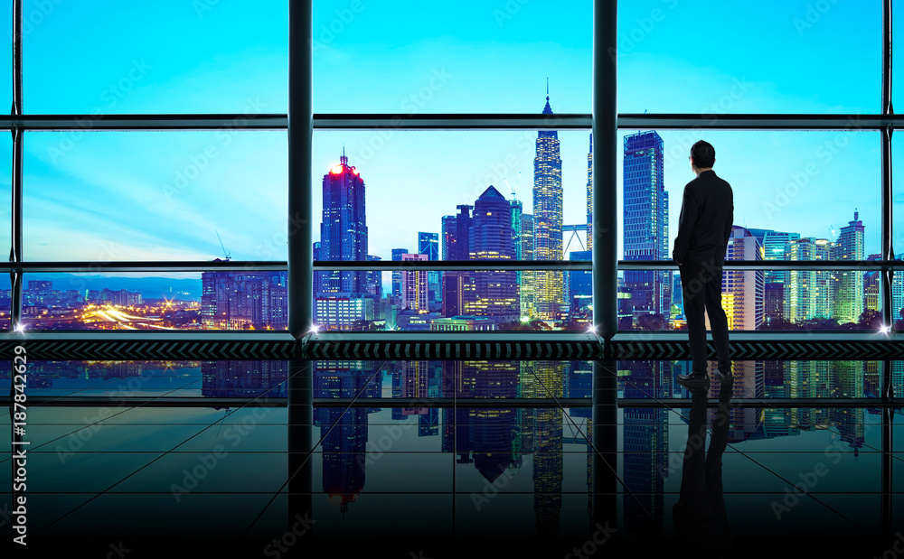 Back view of thoughtful businessman looking through window at big ...