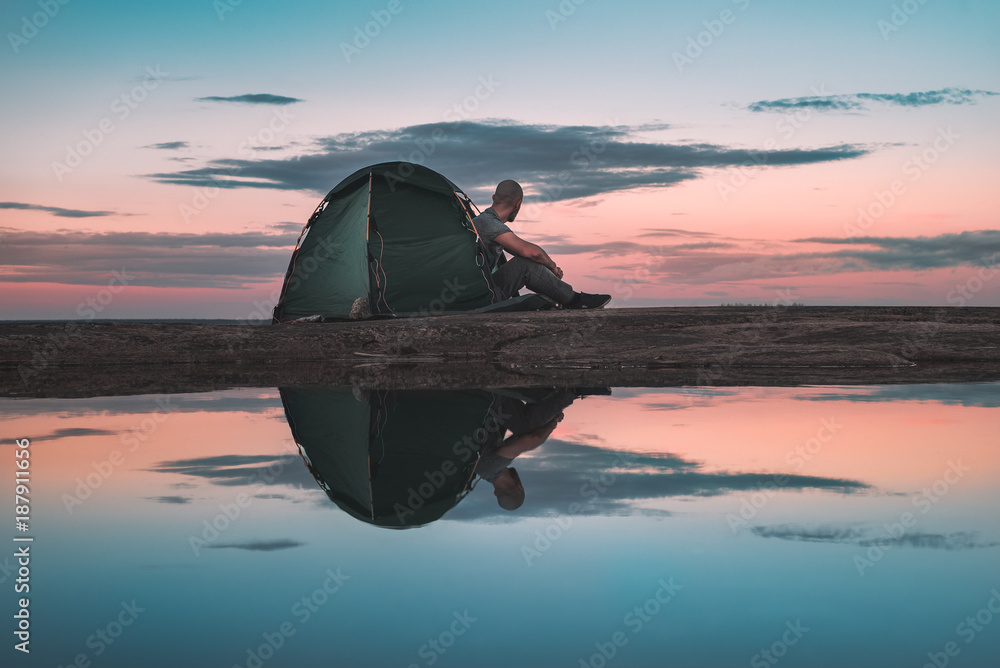 reflection in the water, man in the tent, sunset background Stock Photo ...