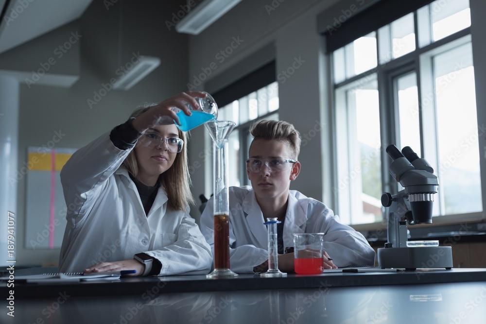 Students doing chemical experiment in college laboratory Stock Photo ...
