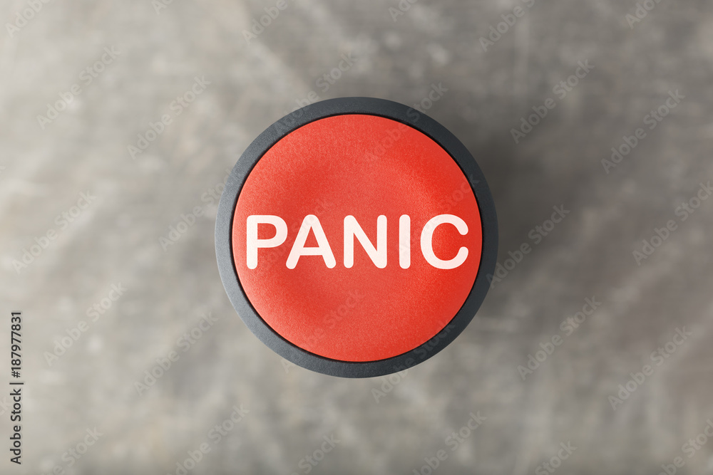 Overhead of Red Panic Button Over Blurred Gray Background Stock Photo ...