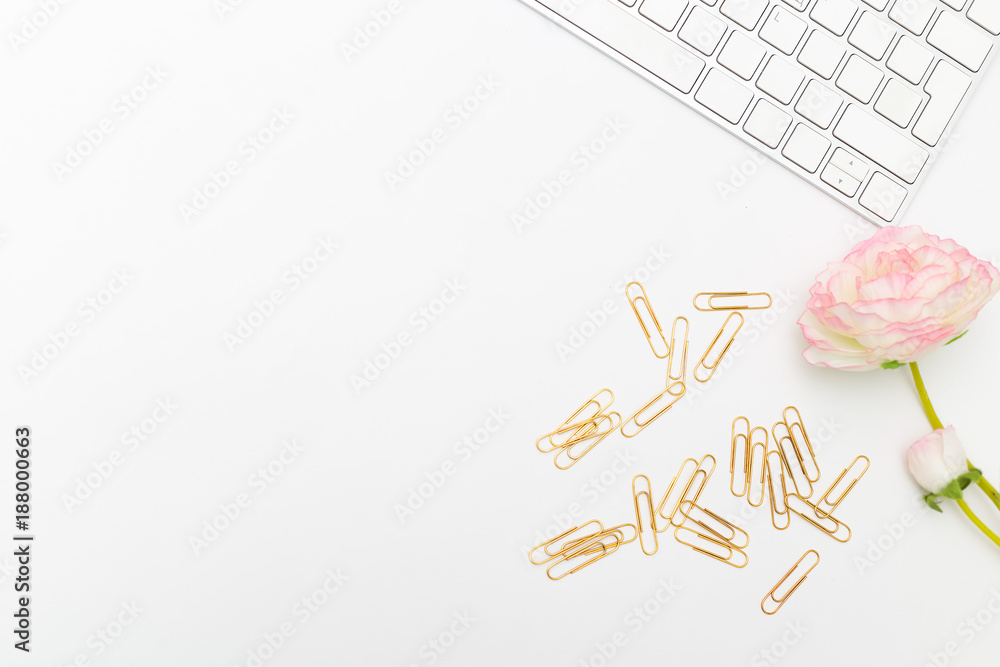 Golden paper clips and keyboard on white background. Office copy space ...
